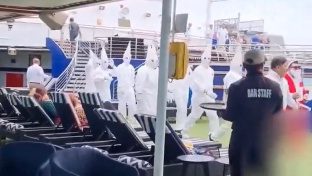 CRUISE SHIP STAFF DRESSED IN COSTUMES RESEMBLING THE KKK