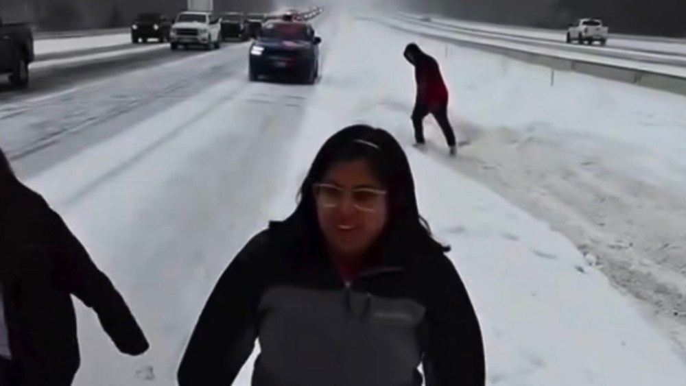 MAN HELPS STRANDED DRIVER STUCK IN DITCH ON MICHIGAN EXPRESSWAY